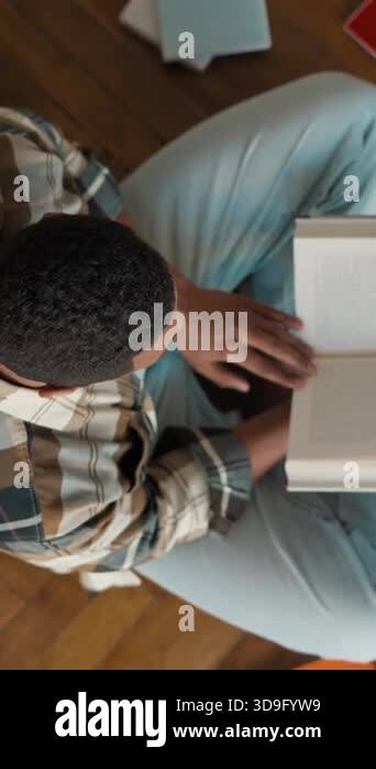 Top view African American man male student in library reading book ...