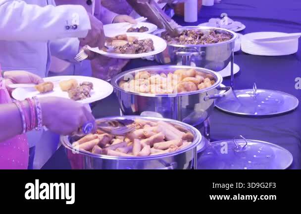 A buffet table is filled with several long, rectangular serving dishes ...