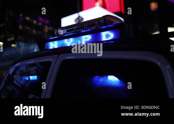 Close nighttime view of NYPD police lights glowing in blue and red ...