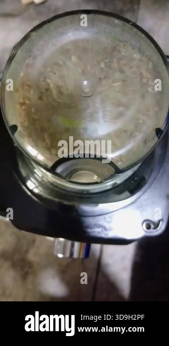 Extreme close up of small blender blending rice and wheat mixture in ...