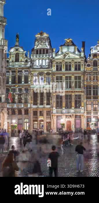 Illuminated Grand Place Guilds facade day to night transition timelapse ...