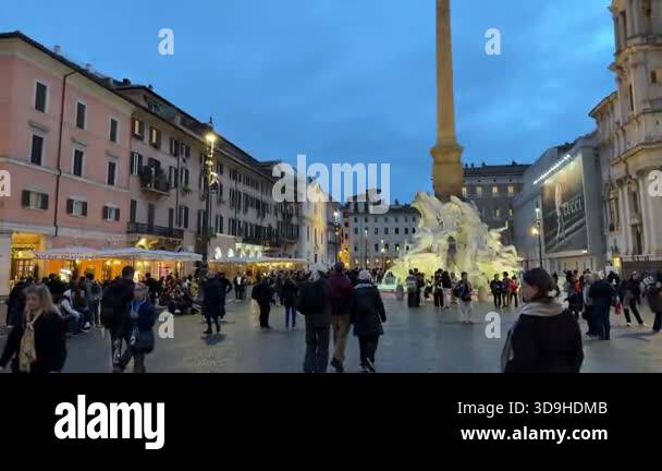 evening scene at Piazza Navona in Rome featuring iconic fountain lively ...