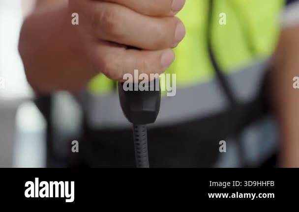 Close-up, Male worker uses wireless barcode reader to read barcode with ...