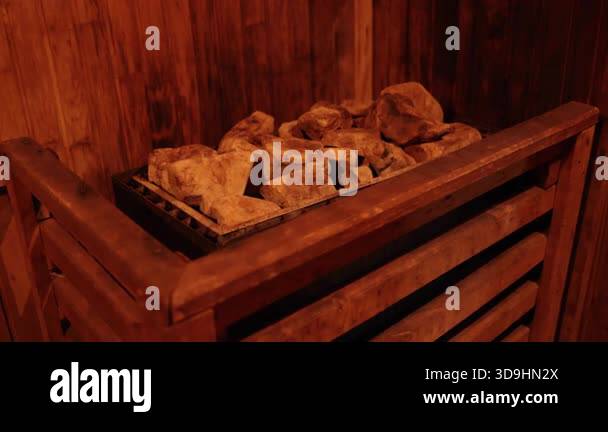 sauna stones, spa ritual, healing heat. Detail view of heated sauna ...