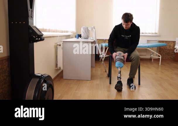 young man, medical recovery, human resilience. In rehabilitation center ...