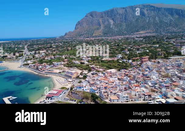 Stunning Aerial View of Coastal Town Surrounded by Mountains and Clear ...