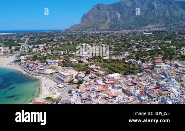 Stunning Aerial View of Coastal Town Surrounded by Mountains and Clear ...