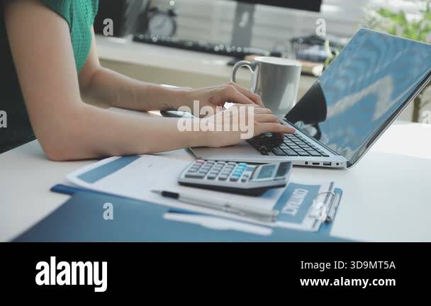 Two financial accountants analysing business spreadsheets on laptop ...