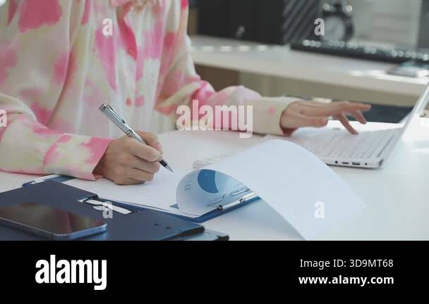 Two financial accountants analysing business spreadsheets on laptop ...