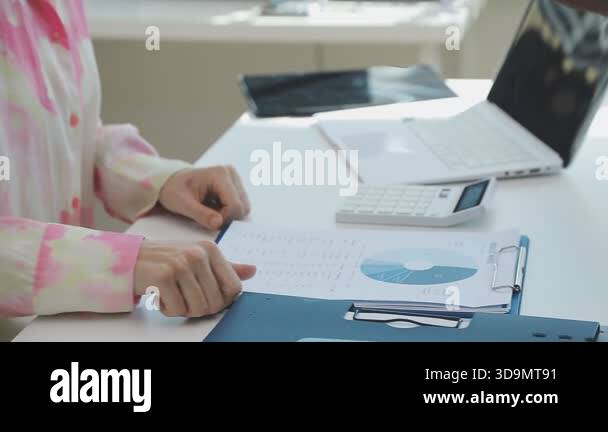 Two financial accountants analysing business spreadsheets on laptop ...