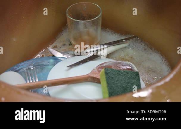 Dirty Dishes and Utensils in a Kitchen Sink with Soapy Water Stock ...