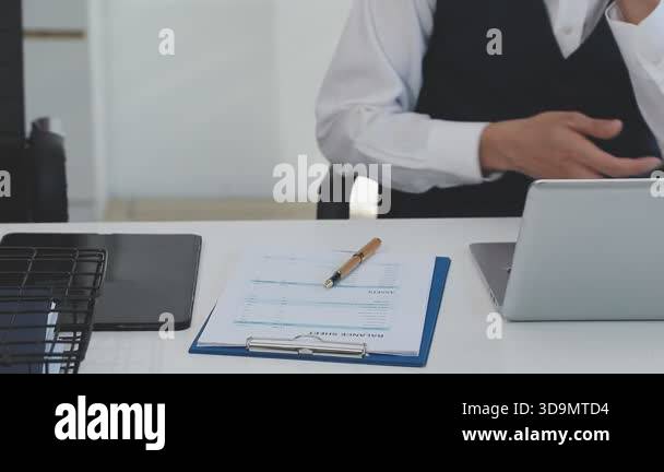 Two financial accountants analysing business spreadsheets on laptop ...