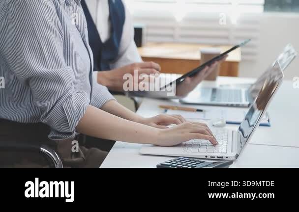 Two financial accountants analysing business spreadsheets on laptop ...