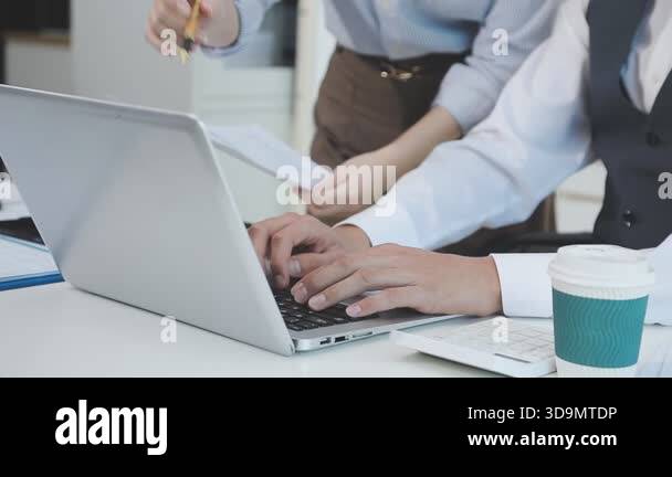 Two financial accountants analysing business spreadsheets on laptop ...