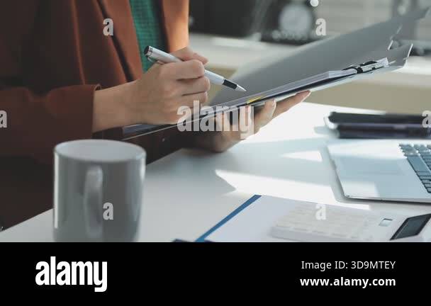 Two financial accountants analysing business spreadsheets on laptop ...