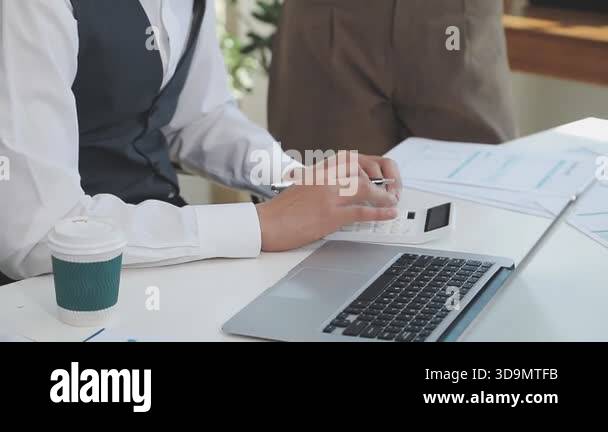 Two financial accountants analysing business spreadsheets on laptop ...