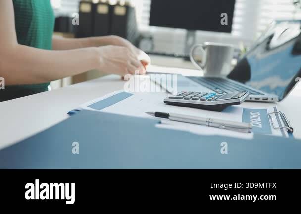 Two financial accountants analysing business spreadsheets on laptop ...