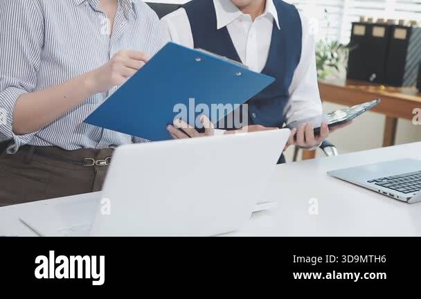 Two financial accountants analysing business spreadsheets on laptop ...