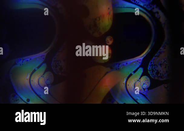 Gasoline texture defocused. Rainbow soap flow. Blue orange light lens ...