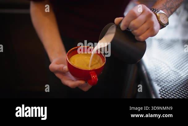 Serving cappuccino. Steamed milk. Barista hand pouring hot frothing ...
