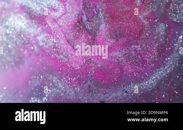 Glitter fluid. Paint splatter. Defocused pink purple silver color ...