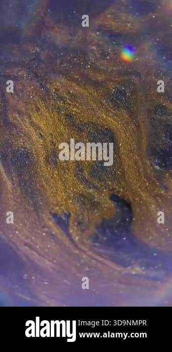 Vertical video. Glitter flow. Blur acrylic stream. Golden blue black water mix ink pigment in ...