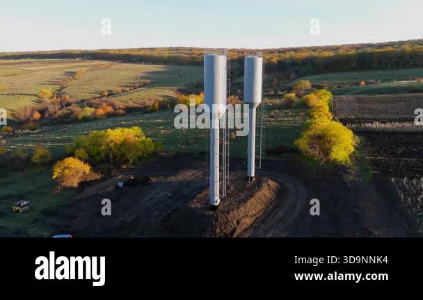 Two water towers dominate the scene in a picturesque rural setting ...