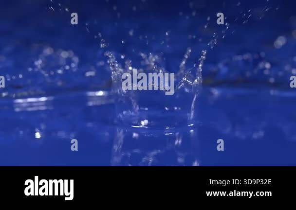 Water droplets collide with the surface, creating stunning splashes and ...