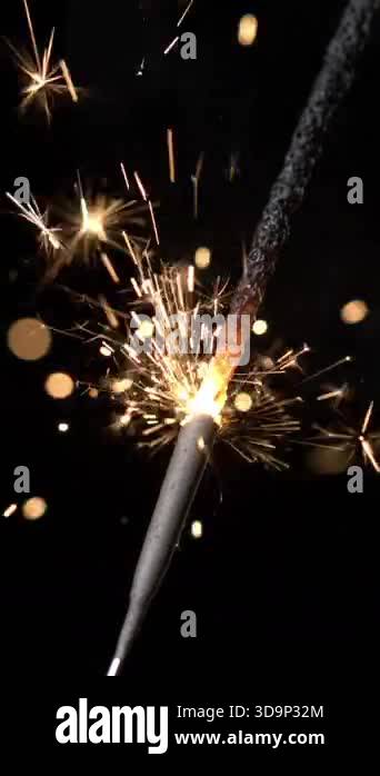 A sparkler lights up the night with bright sparks flying out in all ...