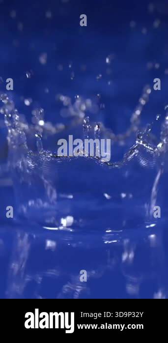 Capturing the moment when water drops hit a bright blue surface ...