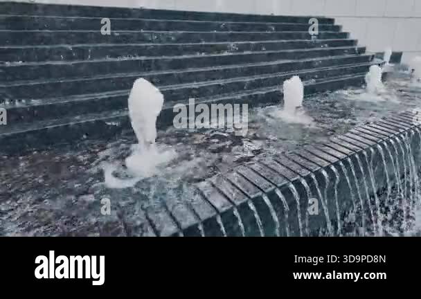 Modern fountain with cascading water jets on stone stairs, Clear ...