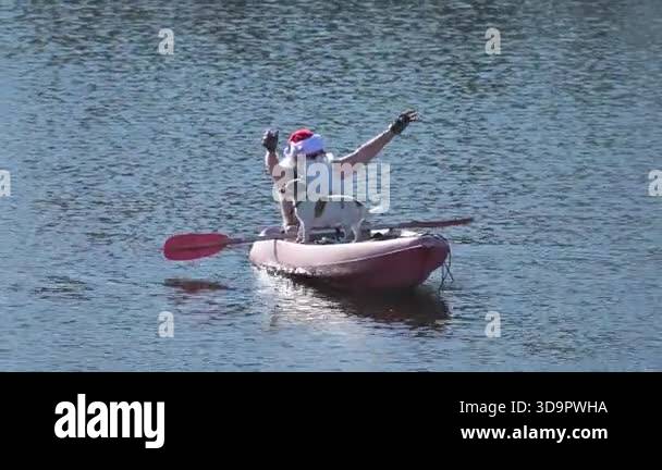 PORT MACQUARIE - DES 01 2025:Santa Claus in kayak wave hello. Santa ...