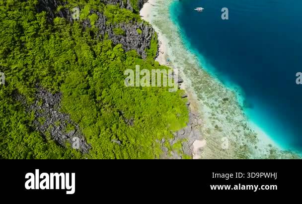 Boats going to white sand beach . Blue sea surrounded by Tapiutan ...