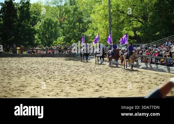 Equestrian performance team riding horses in sandy outdoor arena ...