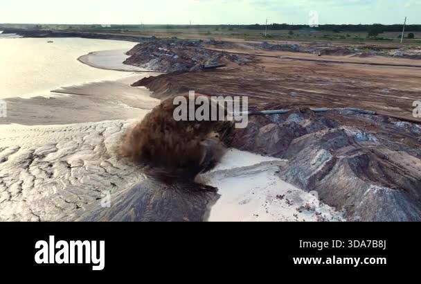 Phosphate mining site in Florida with large pipe ejecting water and ...