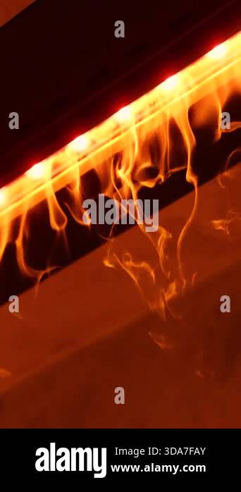 Artistic flame flowing diagonally from left to right over warm toned ...