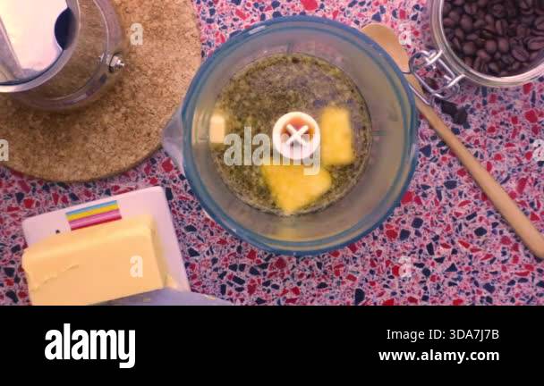 Top view of person making coffee with butter and MCT oil in kitchen ...