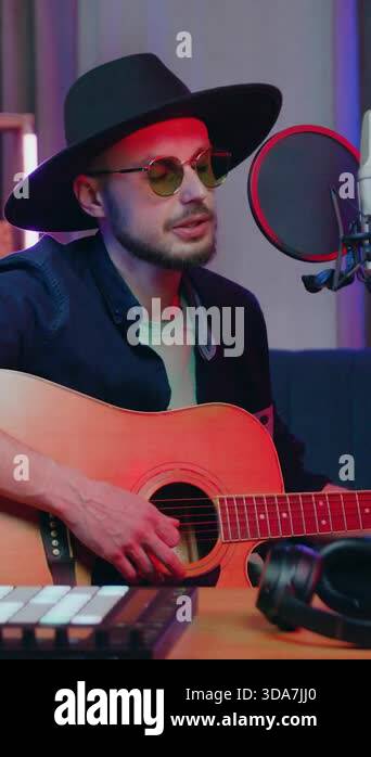 Good-looking successful skillful young bearded guy in black hat and ...