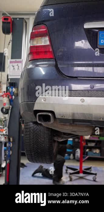 car repair underway, automobile technician working on suv vehicle ...