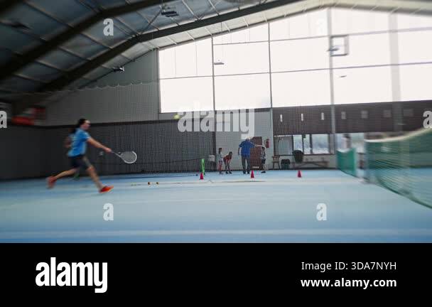 indoor tennis serve, male competitor demonstrates intense serve ...