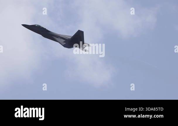 F-22 Raptor executes dynamic aerial maneuvers against a clear sky ...
