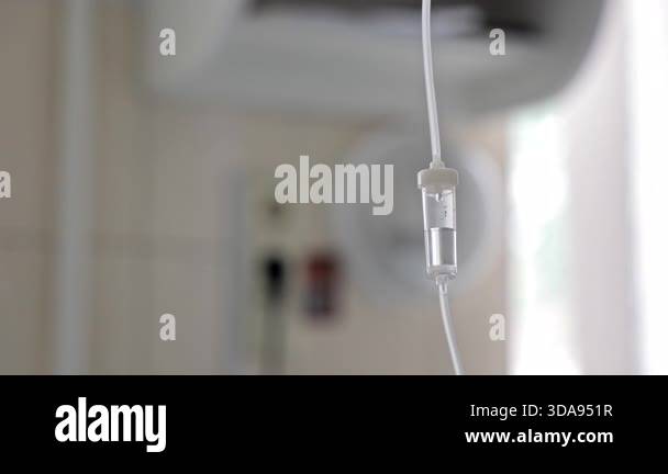 Close up view of the intravenous drip chamber with liquid medicine ...