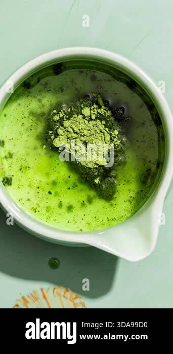 A vibrant stop motion image capturing the process of mixing matcha tea ...