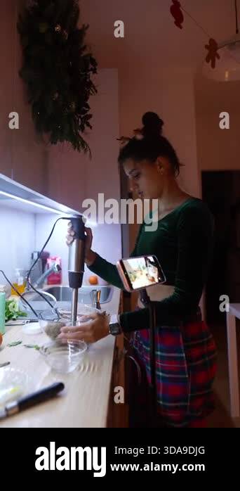 Closeup of woman blending ingredients, Closeup of woman using immersion ...