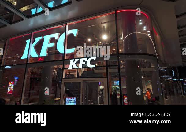 BRUSSELS, BELGIUM - NOVEMBER 26, 2025 - KFC storefront illuminated at ...