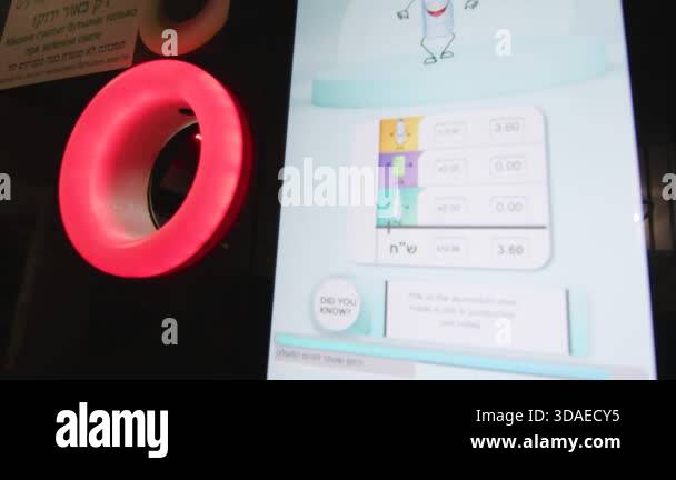 Putting plastic bottle in recycling system, scanning barcode and it ...