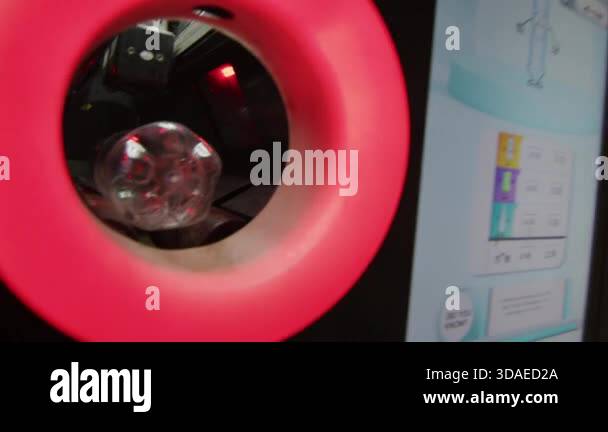 Putting plastic bottle in recycling system, scanning barcode and it ...
