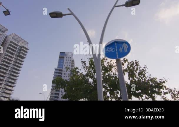 Road sign of Bicycle lane and pedestrian walkway in the city. High-rise ...