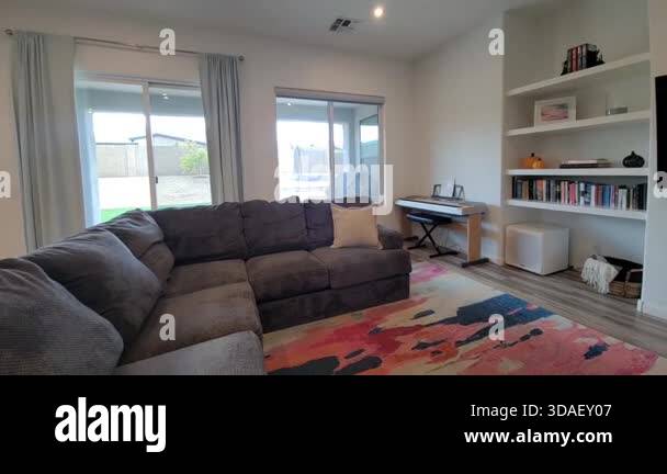 Bright Living Room With Large Sectional, Colorful Rug, BuiltIn Shelves ...