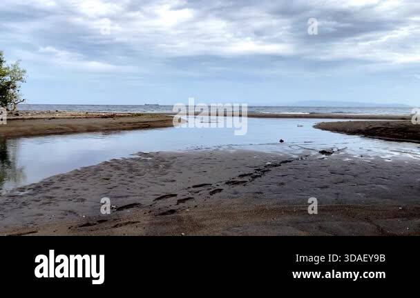 Sandbar is formed at low tide of water waves gently caress warm sand ...